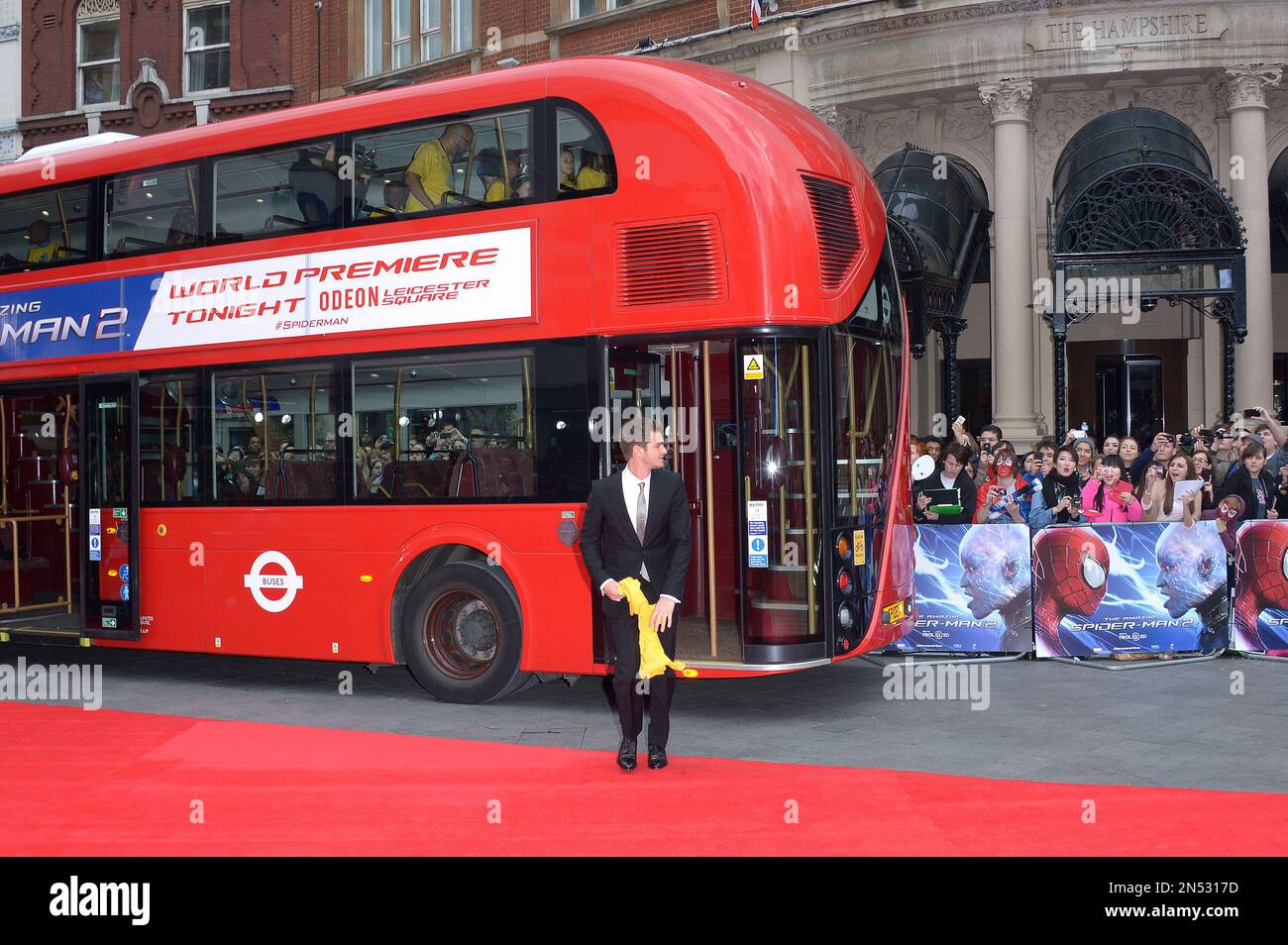 Actor Andrew Garfield arrives on the red carpet in a double decker bus ...