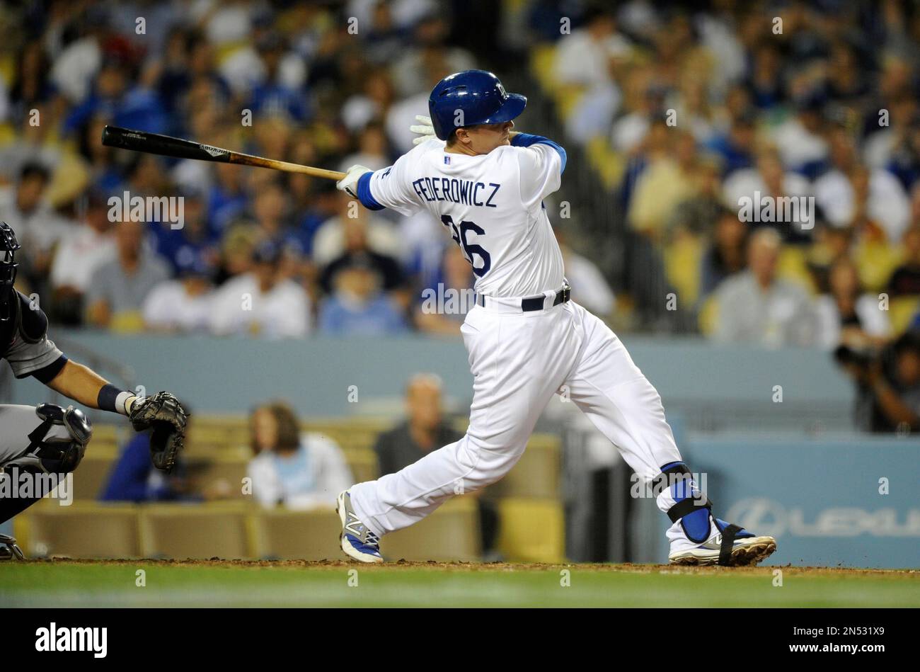 Los Angeles Dodgers' Tim Federowicz follows through on a hit for a ...
