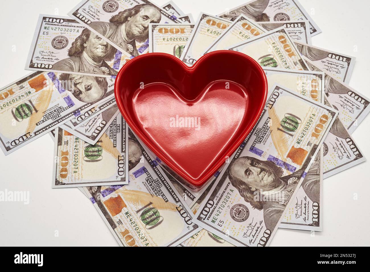 for the love of money heart shape one hundred dollar bills on white ...