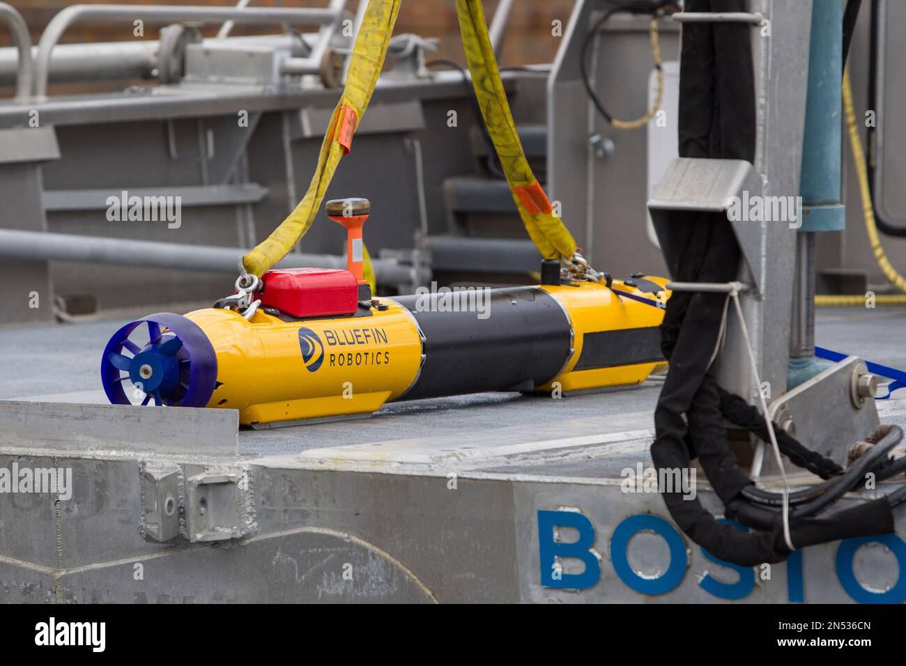 A submarine built by Bluefin Robotics sits on the back of a research ...