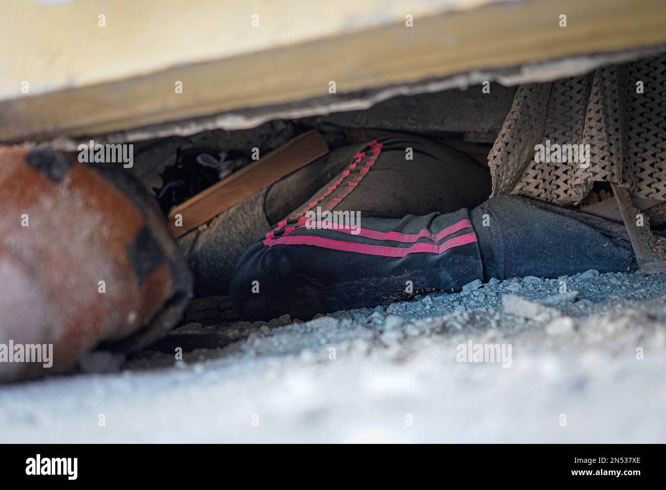 (EDITORS NOTE: Image depicts death) Feet of a corpse under the rubble ...