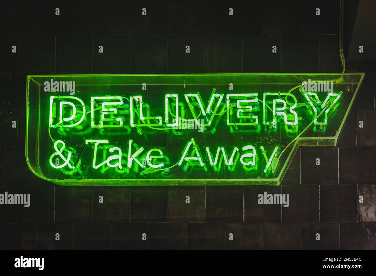 Restaurant of a Green Neon Delivery and Take Away Sign Stock Photo - Alamy
