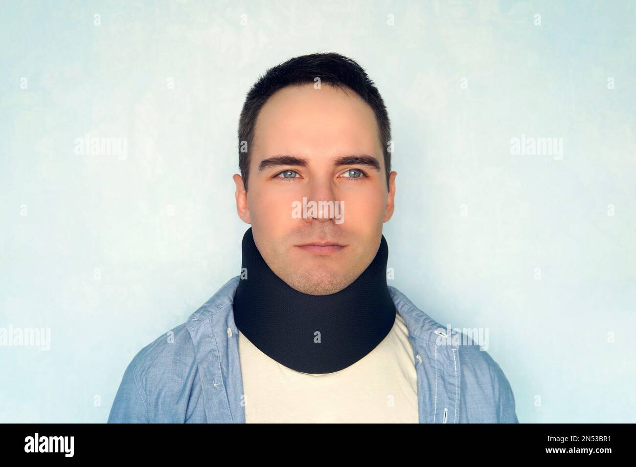 A guy with a bad neck in a black neck collar to stabilize the cervical ...