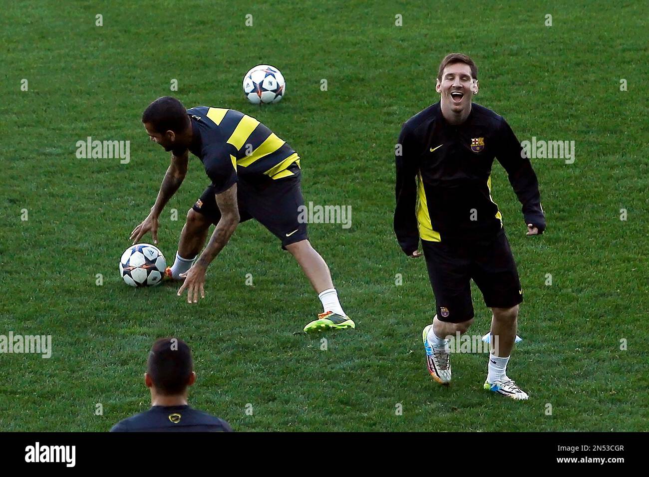 FC Barcelona's Lionel Messi, right, laughs during a training session at ...