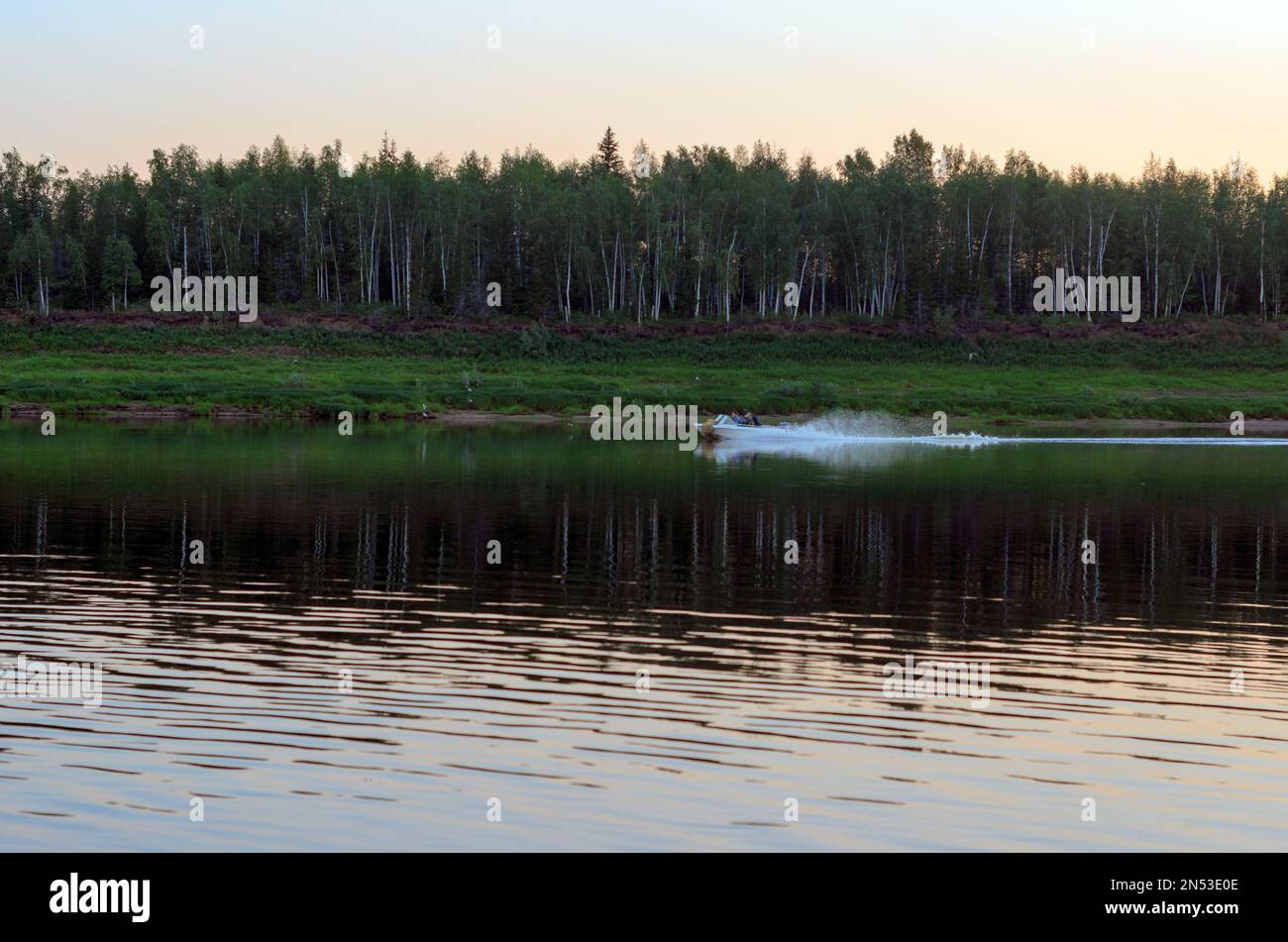 Boat with people going on the river Vilyuisk in the North of Yakutia on ...