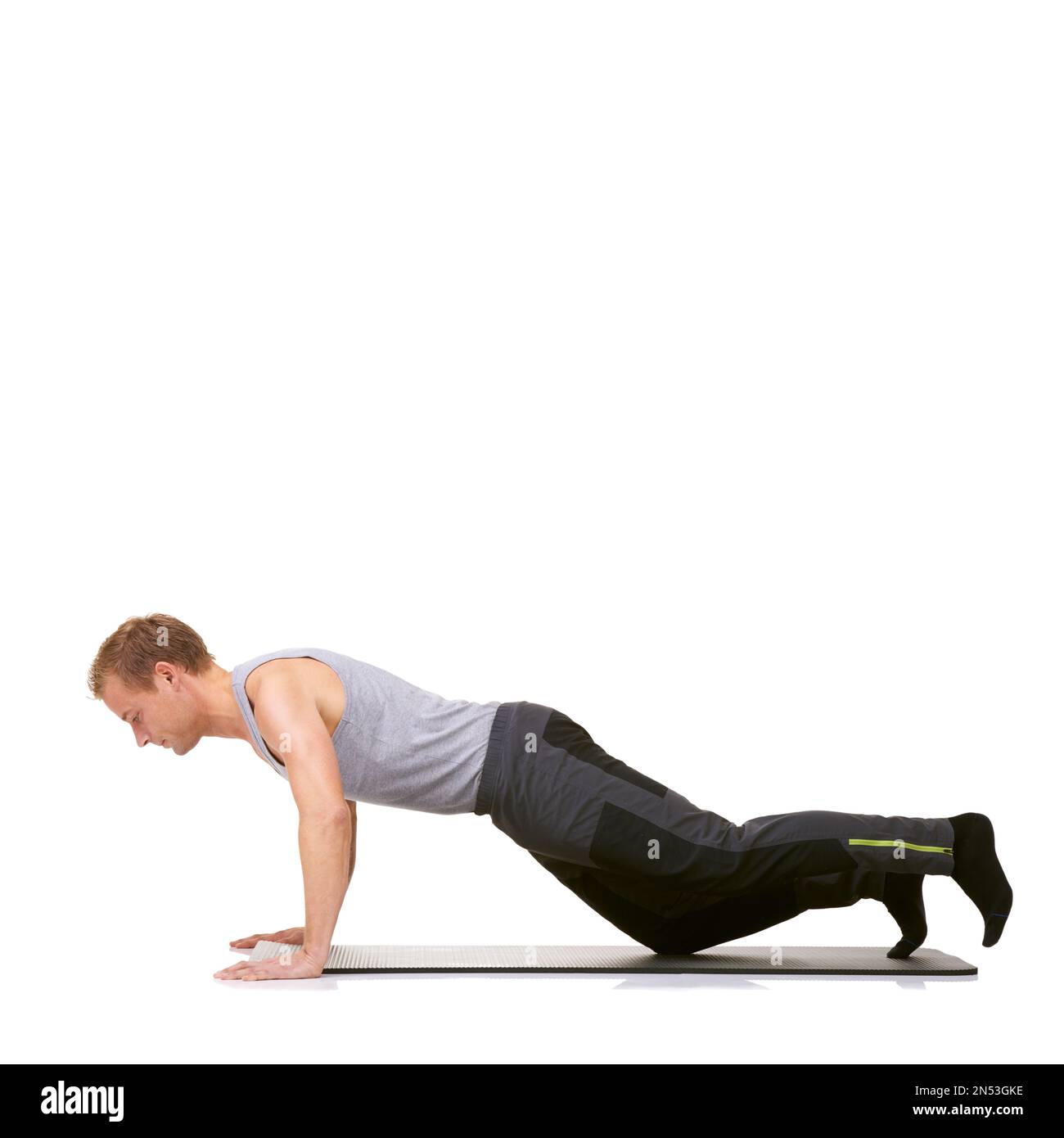 Push-ups working his chest muscles. A fit young man working out on his ...