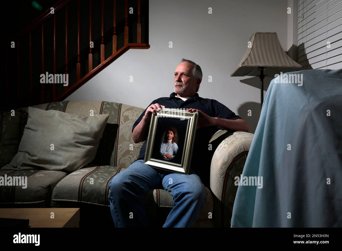Jim Hall poses for a photo holding a picture of his daughter, Kelli ...