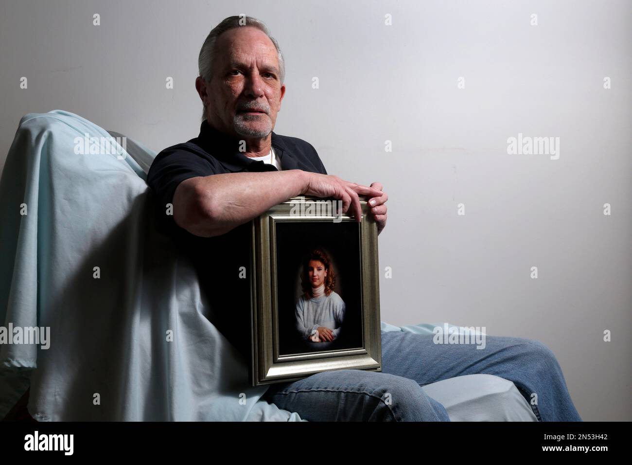 Jim Hall poses for a photo holding a picture of his daughter, Kelli ...