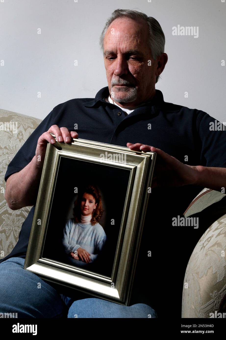 Jim Hall poses for a photo holding a picture of his daughter, Kelli ...