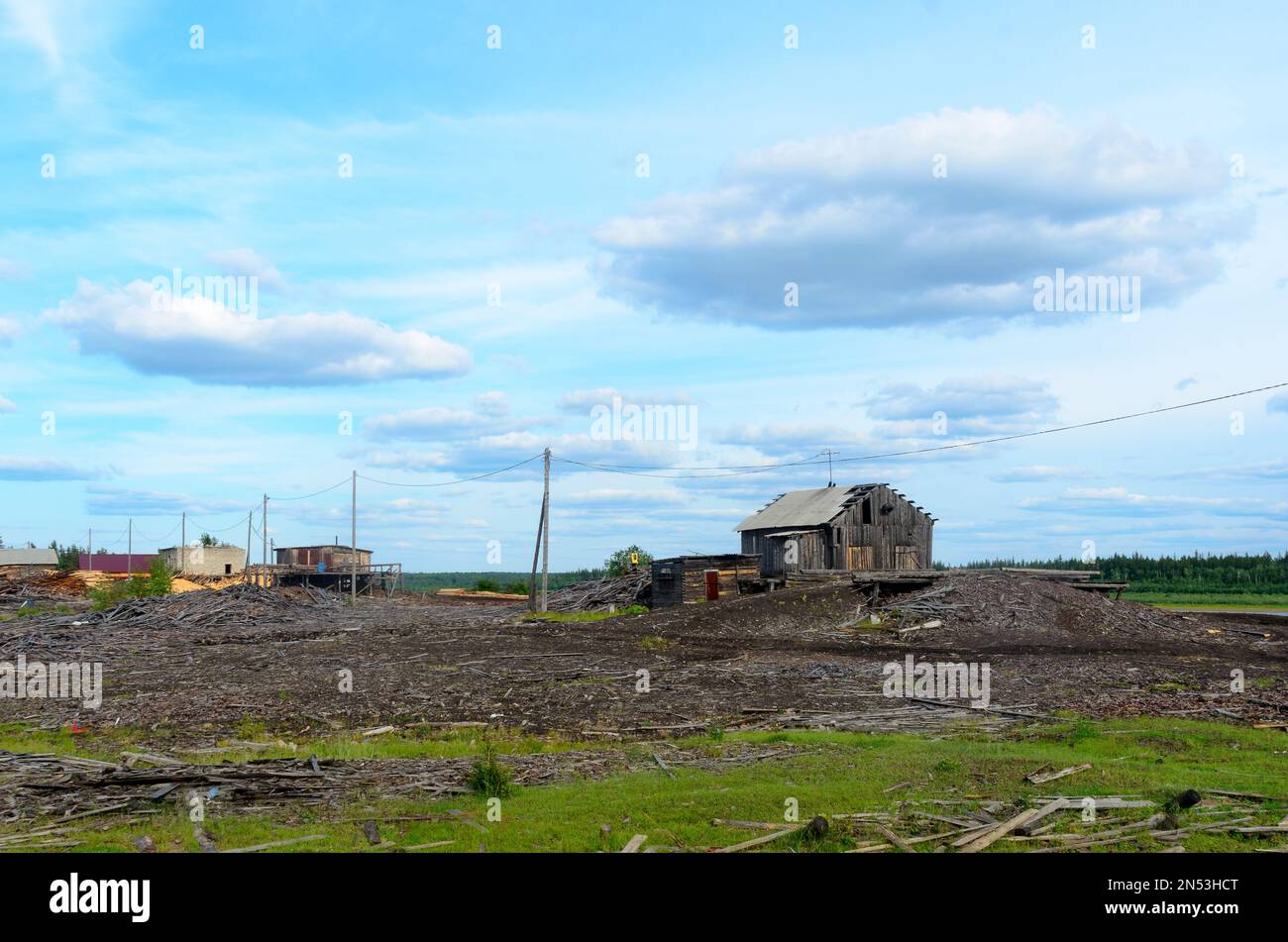An old abandoned sawmill stands on the Bank of the Northern river and ...