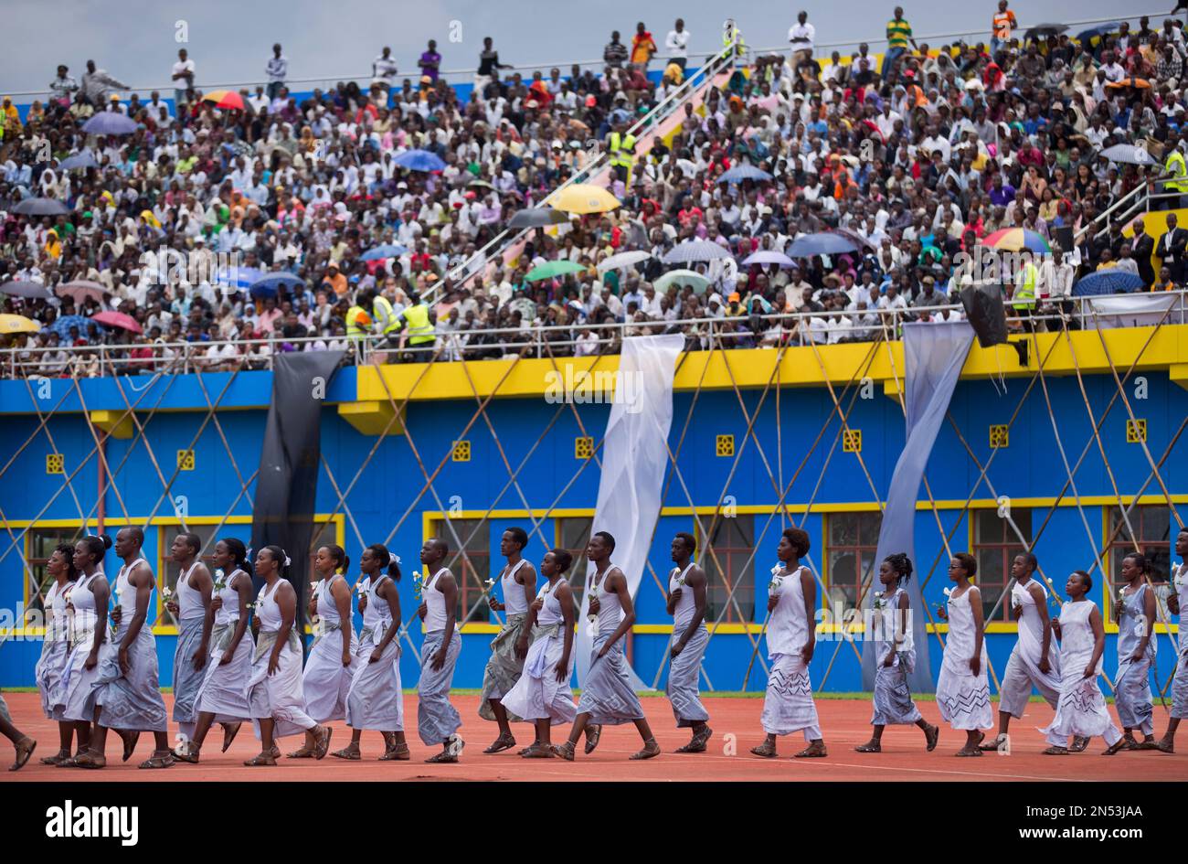 Performers re-enacting some of the events enter a public ceremony to ...