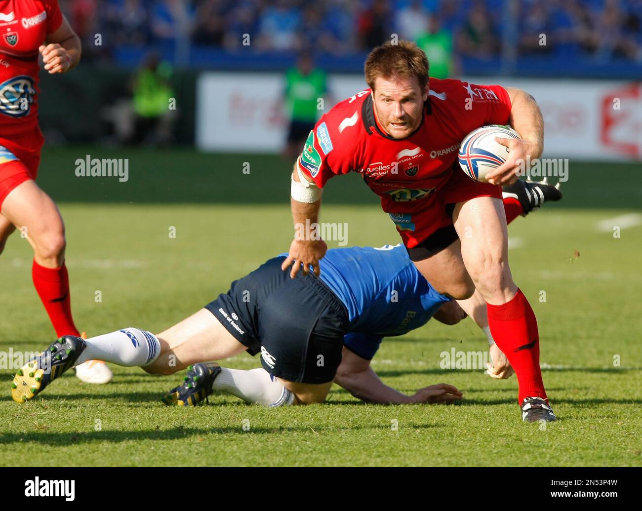 Toulon's hooker Craig Burden, right, of South Africa, runs past ...