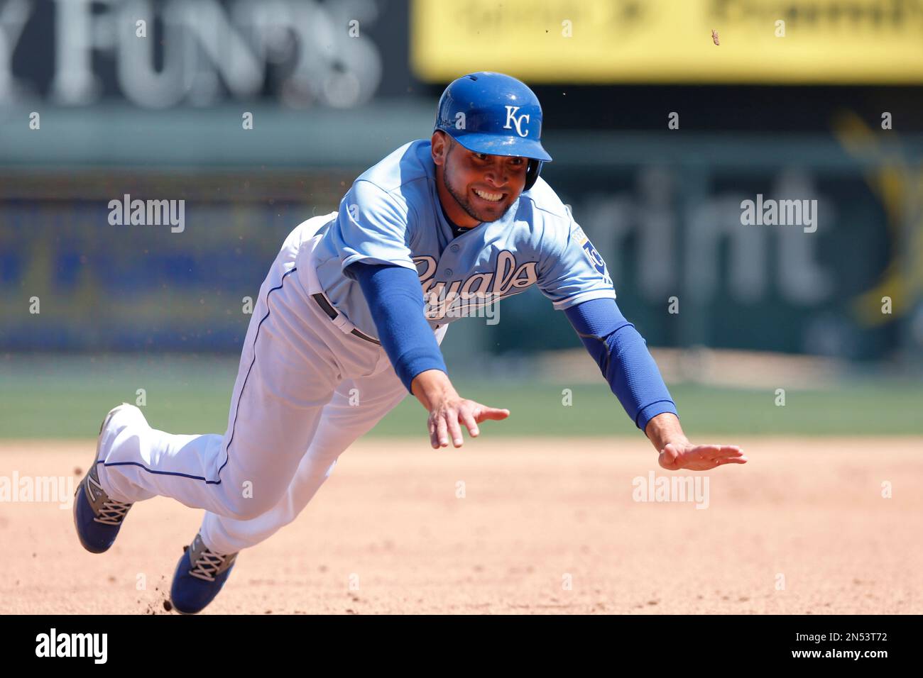 Kansas City Royals' Omar Infante dives for third base on a hit by ...