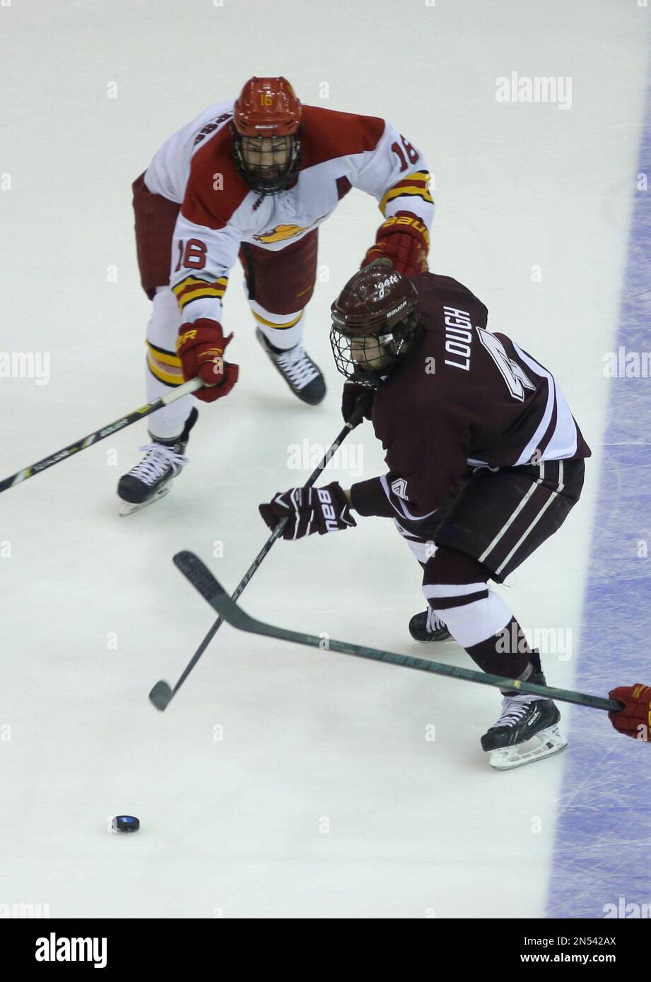 Colgate defenseman Kevin Lough (4) takes the puck past Ferris State ...