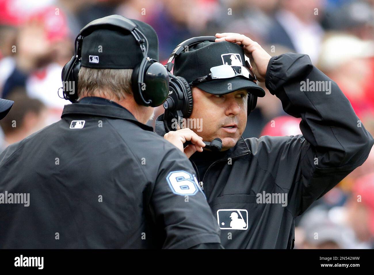 Umpires Jim Joyce, left, and Doug Eddings talk on head phones as they ...