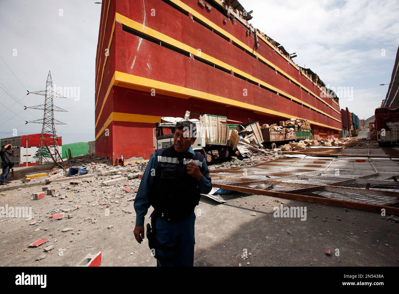 A security guard patrols the earthquake ravaged Duty Free Zone of ...