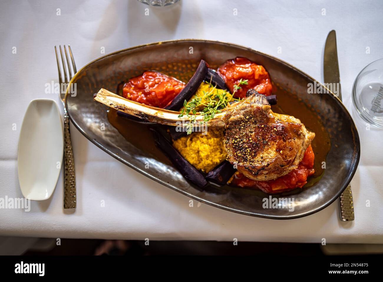 A top view of a lamb rib with vegetables on the table at a restaurant ...