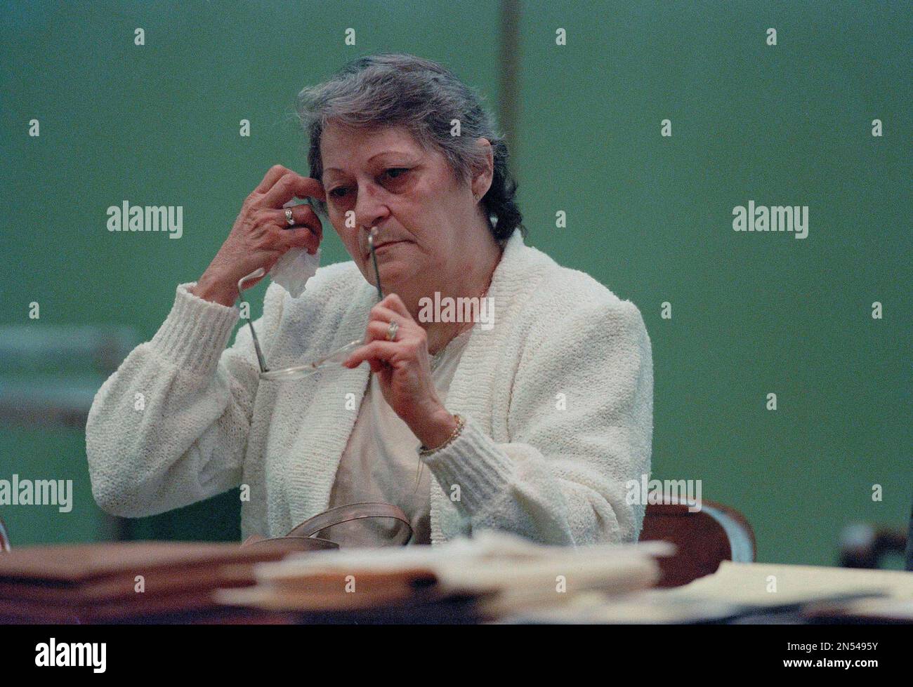 Mary Stiles wipes away a tear as she listens to opening statements in ...