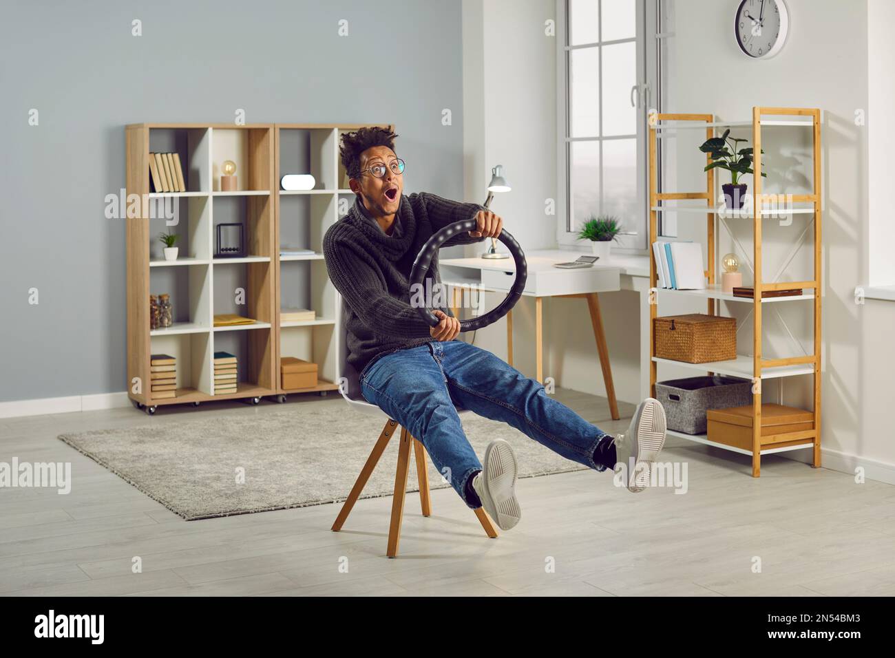 Funny, crazy man pretending to drive an invisible car at a great speed ...