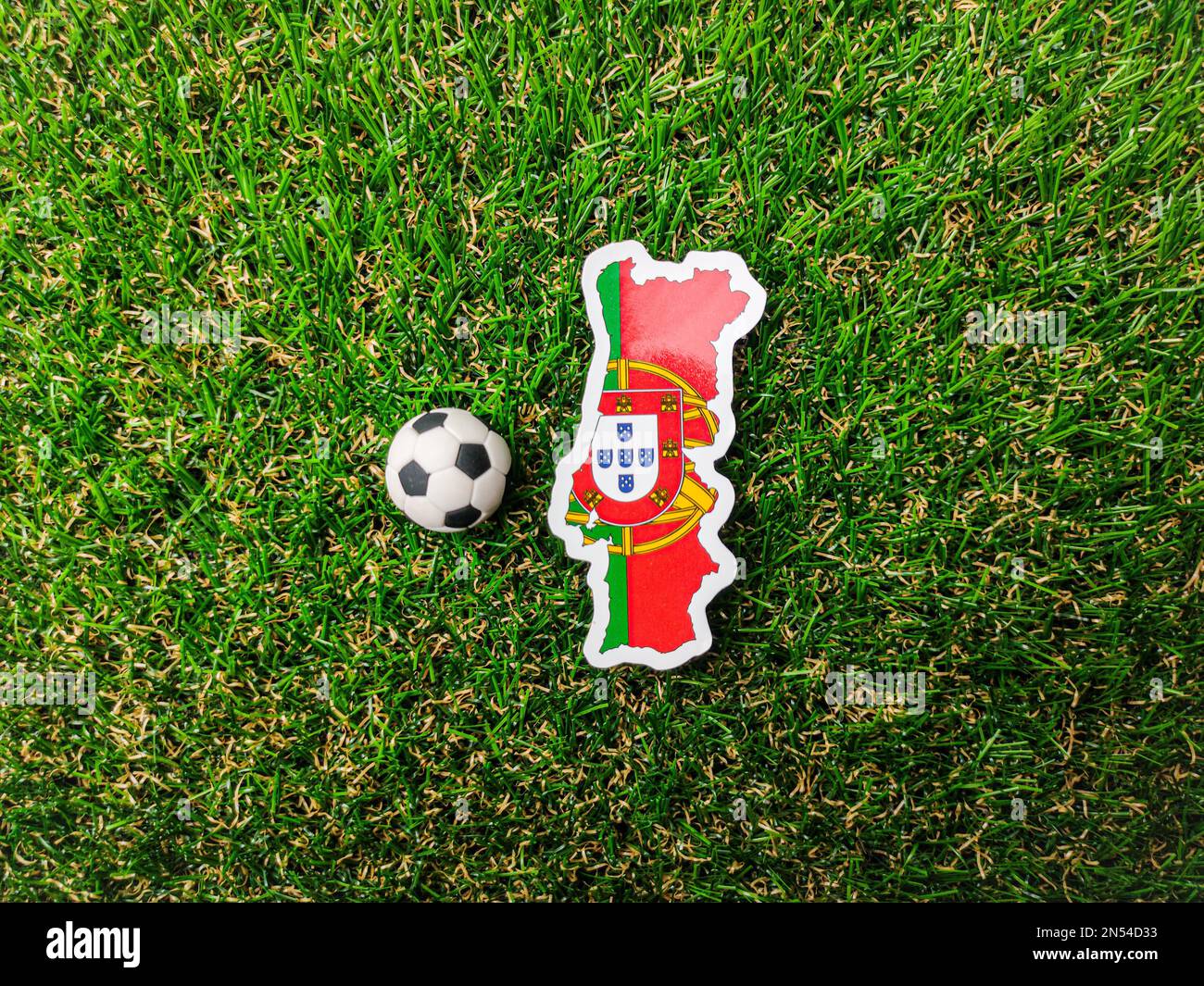 A ball and Portugal flag sticker is on a green field Stock Photo - Alamy