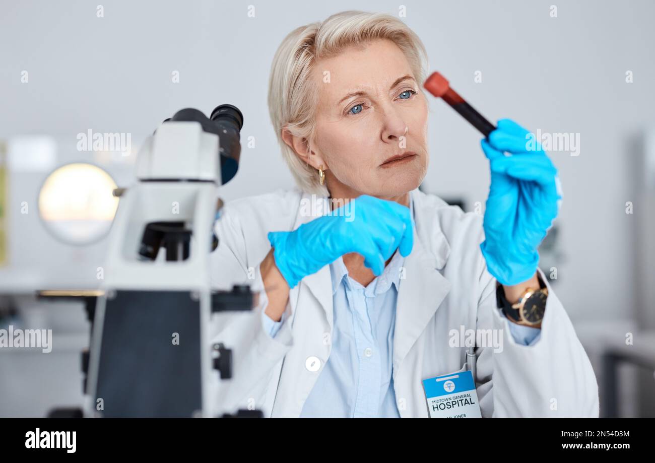Lab tech holding a blood sample hi-res stock photography and images - Alamy