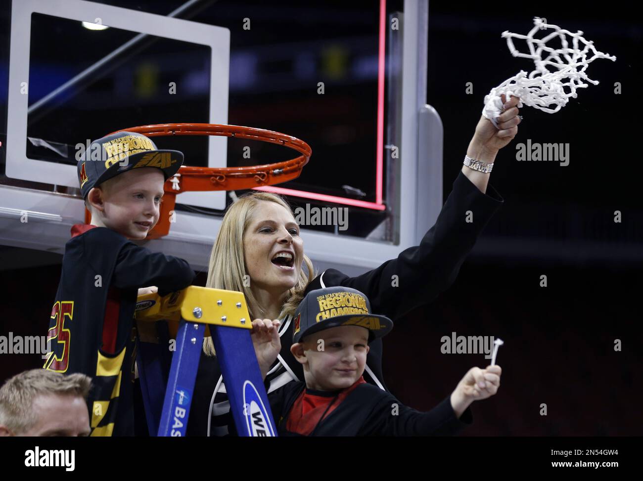 Maryland coach Brenda Frese holds up the net while joined by her sons ...