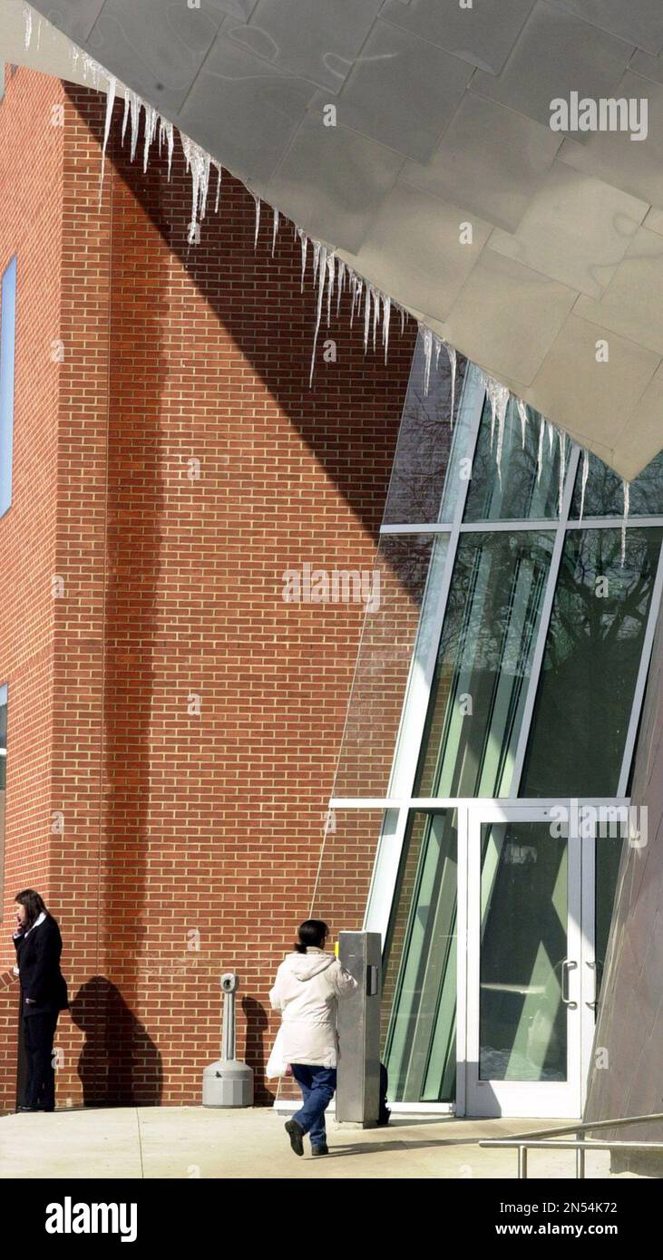 A student walks into the Peter B. Lewis building as ice dangles from ...