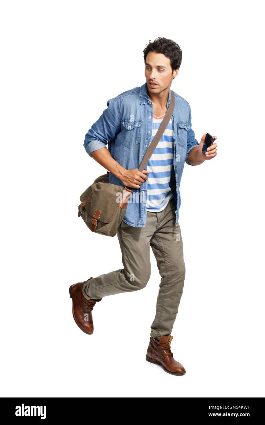 Running late. A handsome young man running against a white background ...