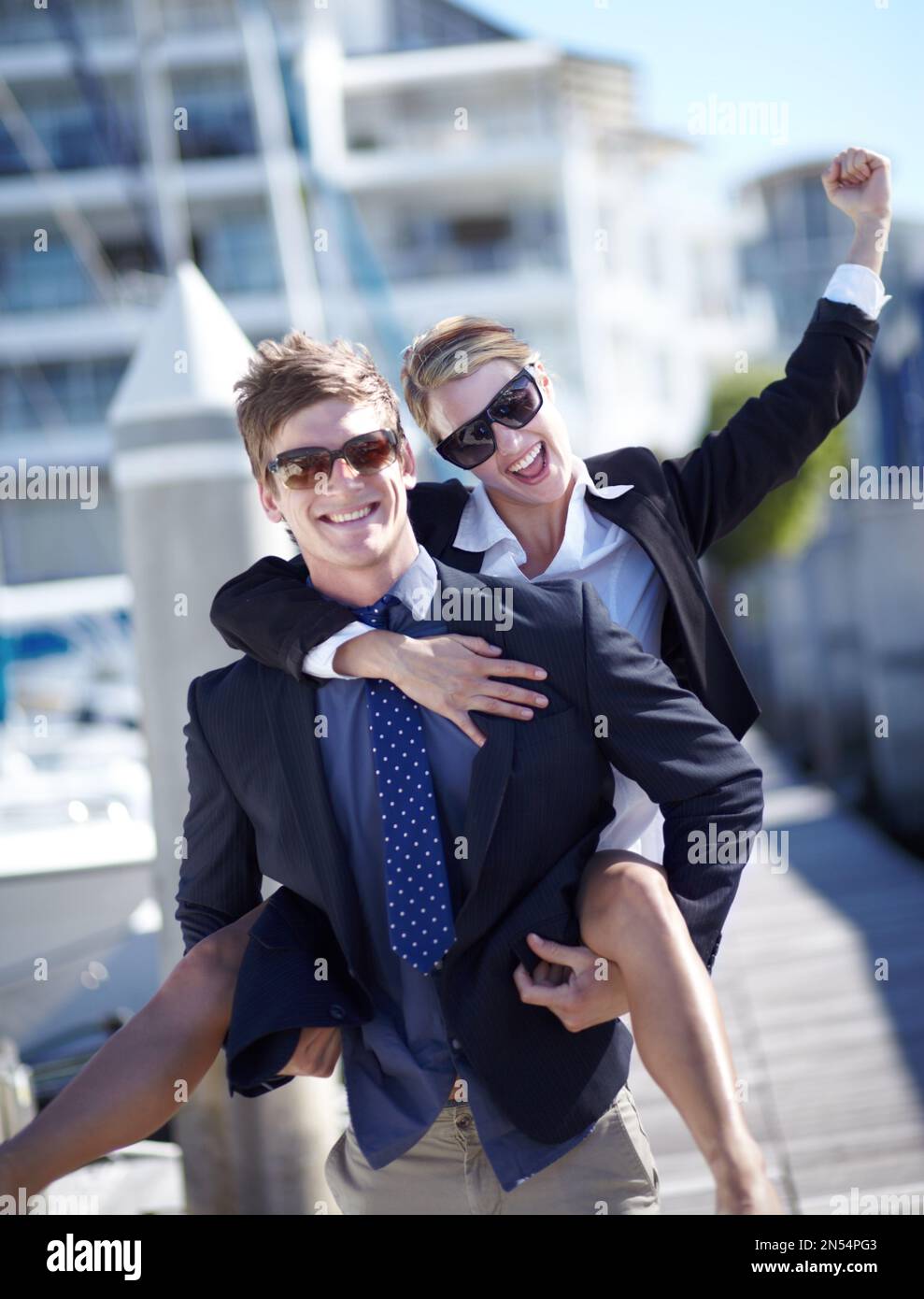 Making corporate life interesting. Young business couple celebrating ...