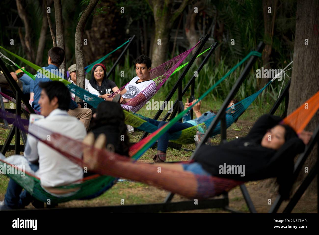 Despite intermittent rain, concert goers relax in hammocks at the 15th ...