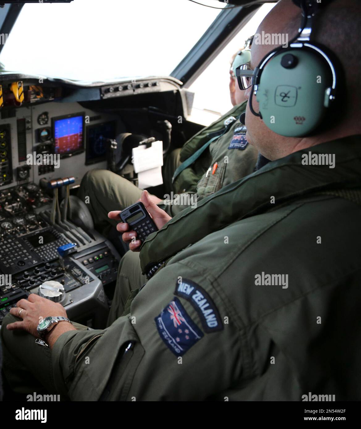 Royal New Zealand Air Force Sgt. Paul Allan uses a calculator to work ...