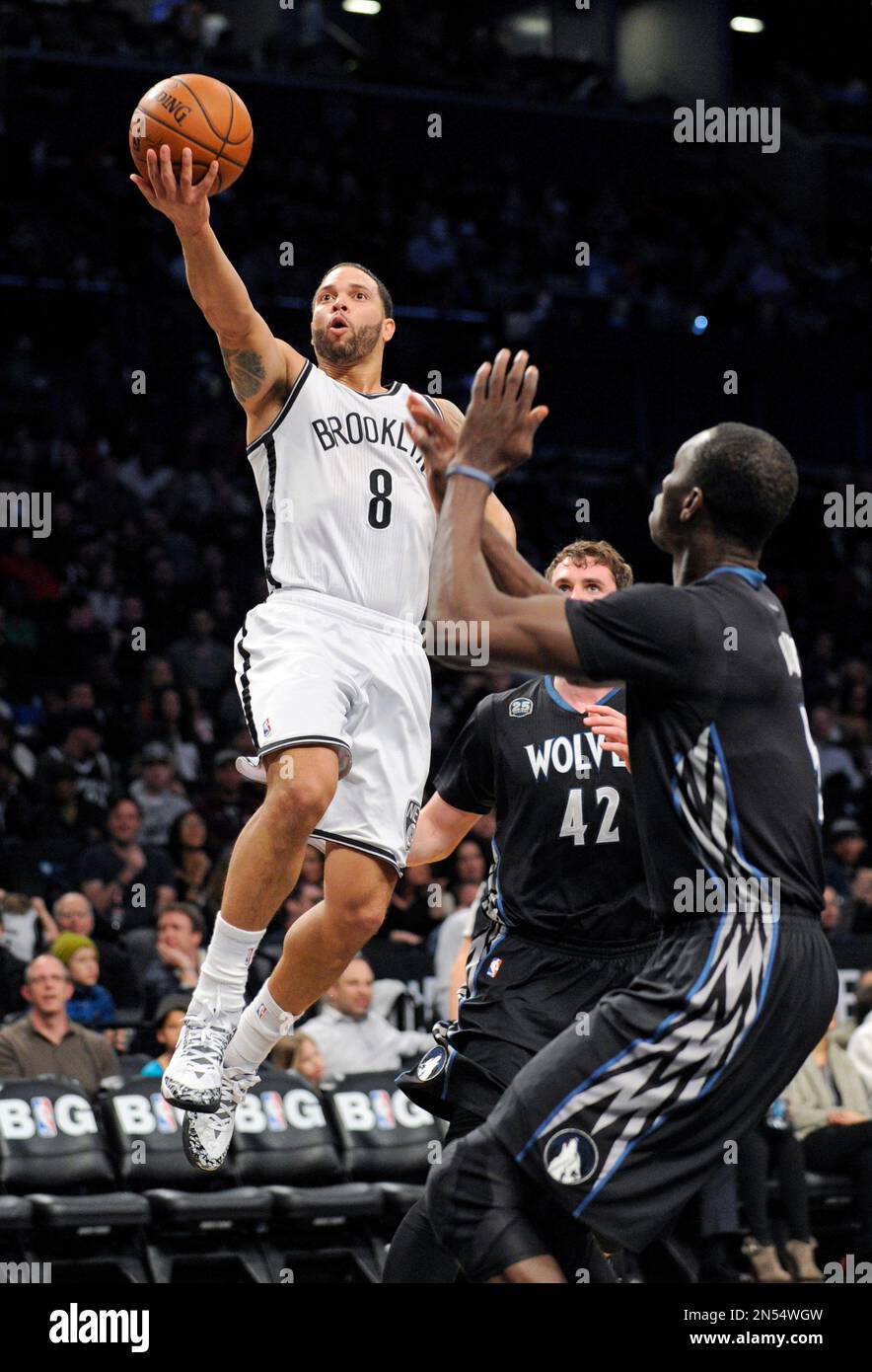 Brooklyn Nets' Deron Williams (8) puts up a shot against the Minnesota ...