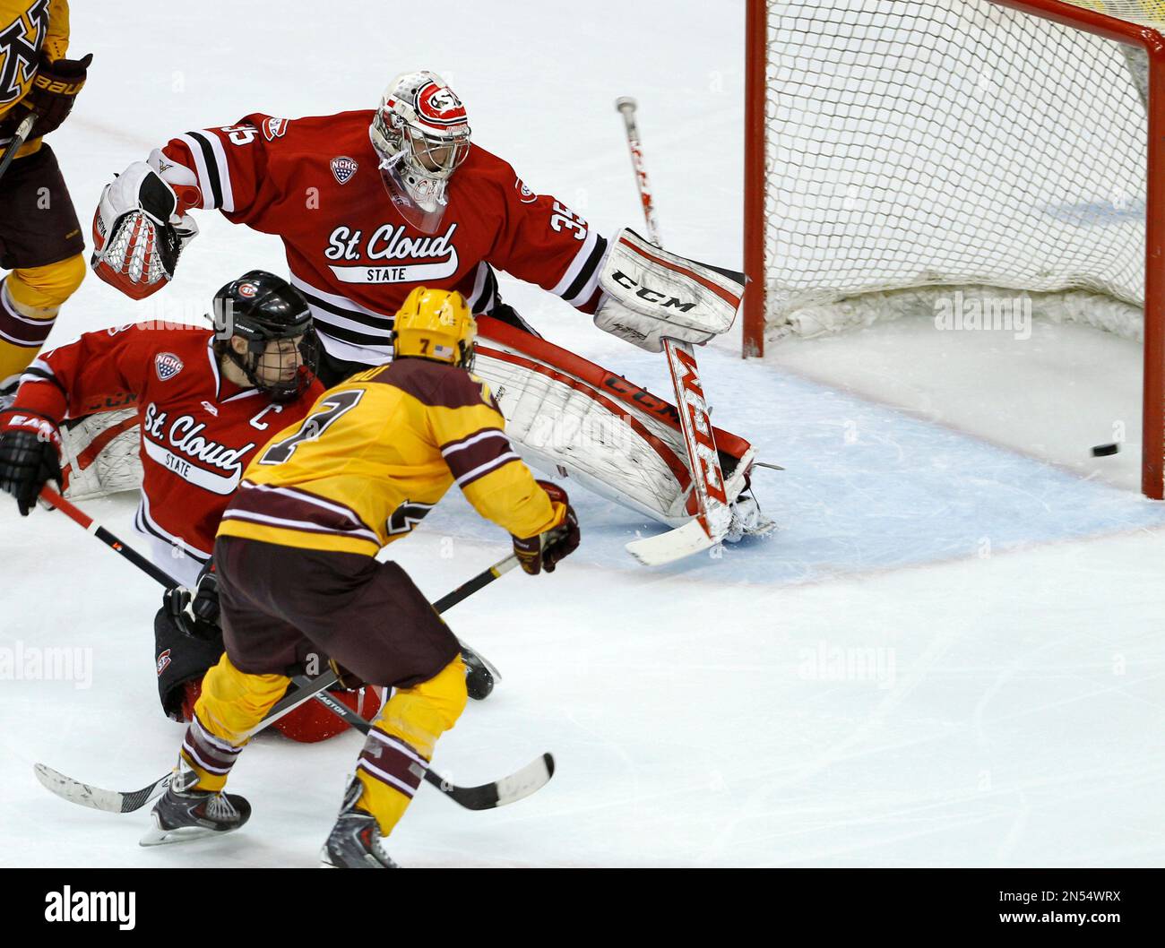 Minnesota forward Kyle Rau (7) scores on St. Cloud State goalie Charlie ...