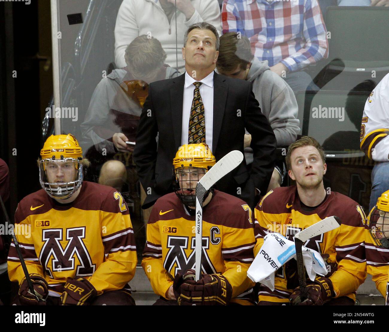 Minnesota head coach Don Lucia, top, checks the scoreboard during the ...
