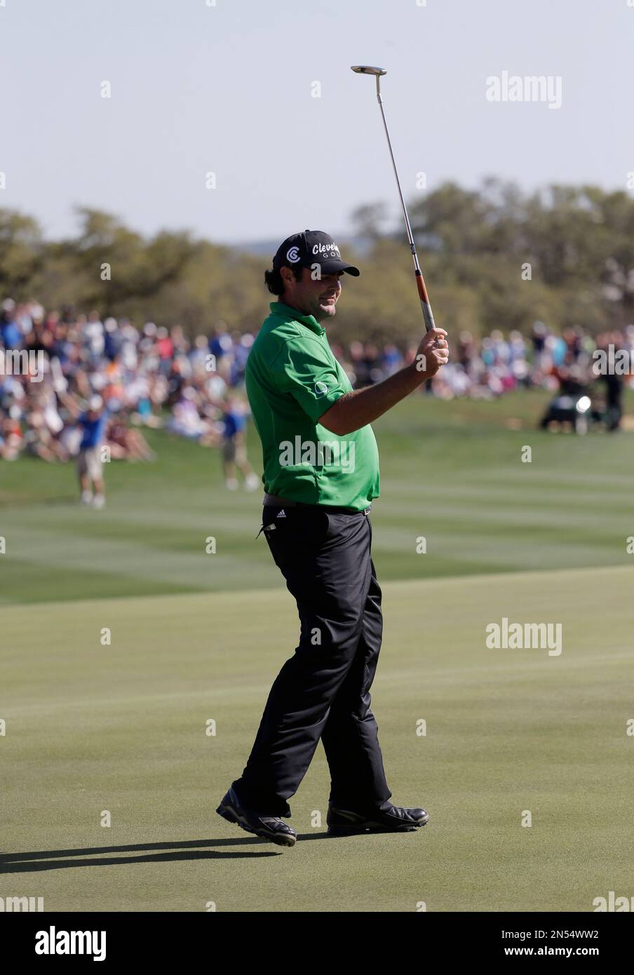 Steven Bowditch, of Australia, raises his putter after making his final ...