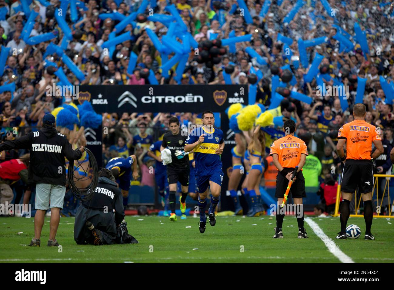 Boca Juniors' Juan Roman Riquelme, center, enters the field for an ...