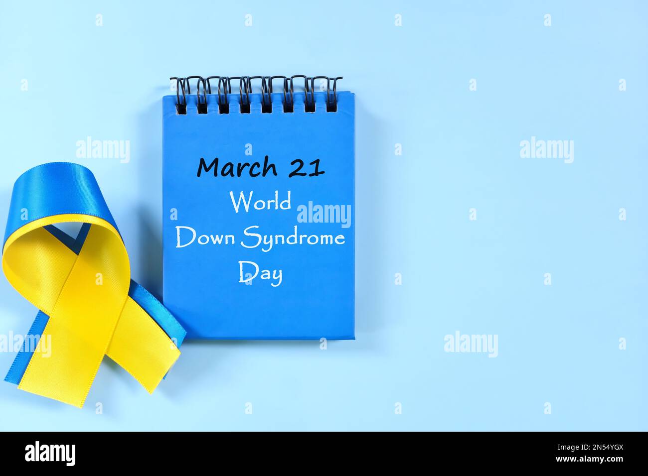 March 21 as World Down Syndrome Day date reminder on blue desk calendar ...