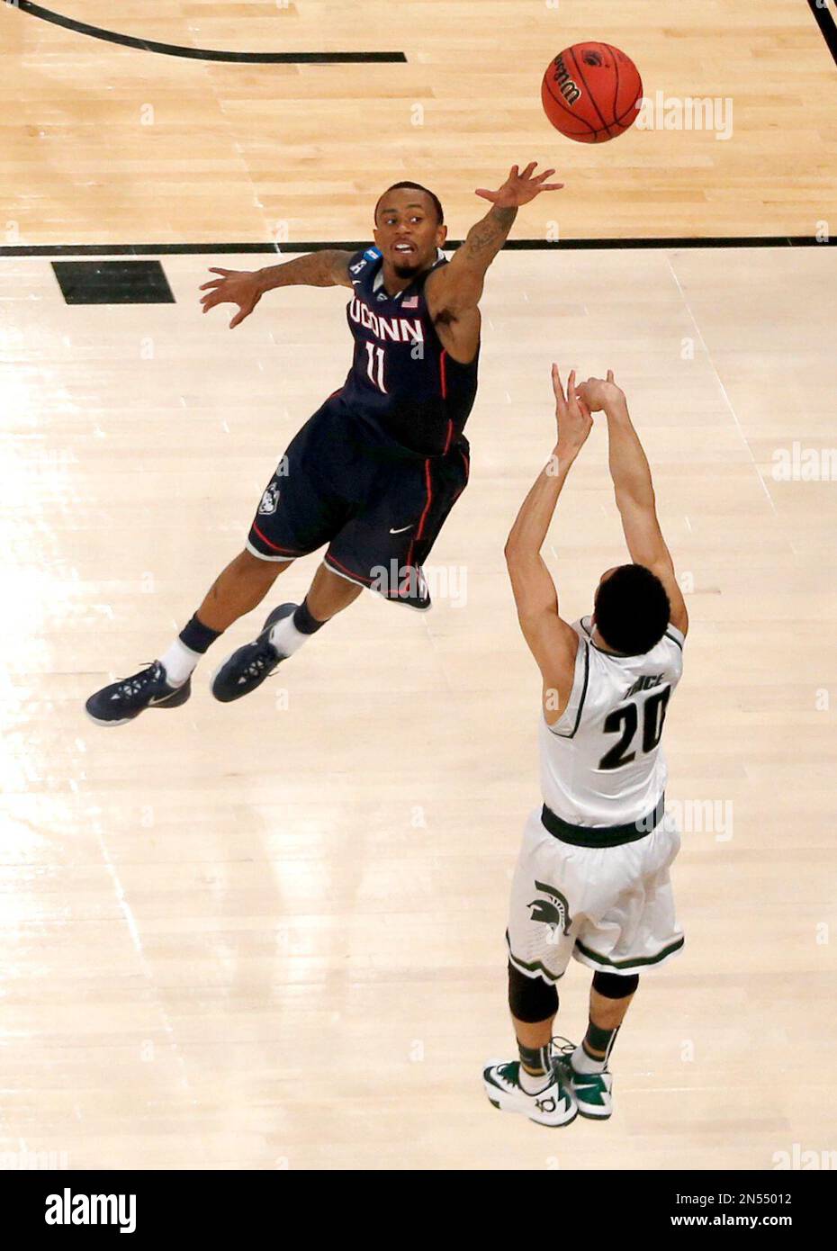 Michigan State guard Travis Trice (20) shoots against Connecticut guard ...