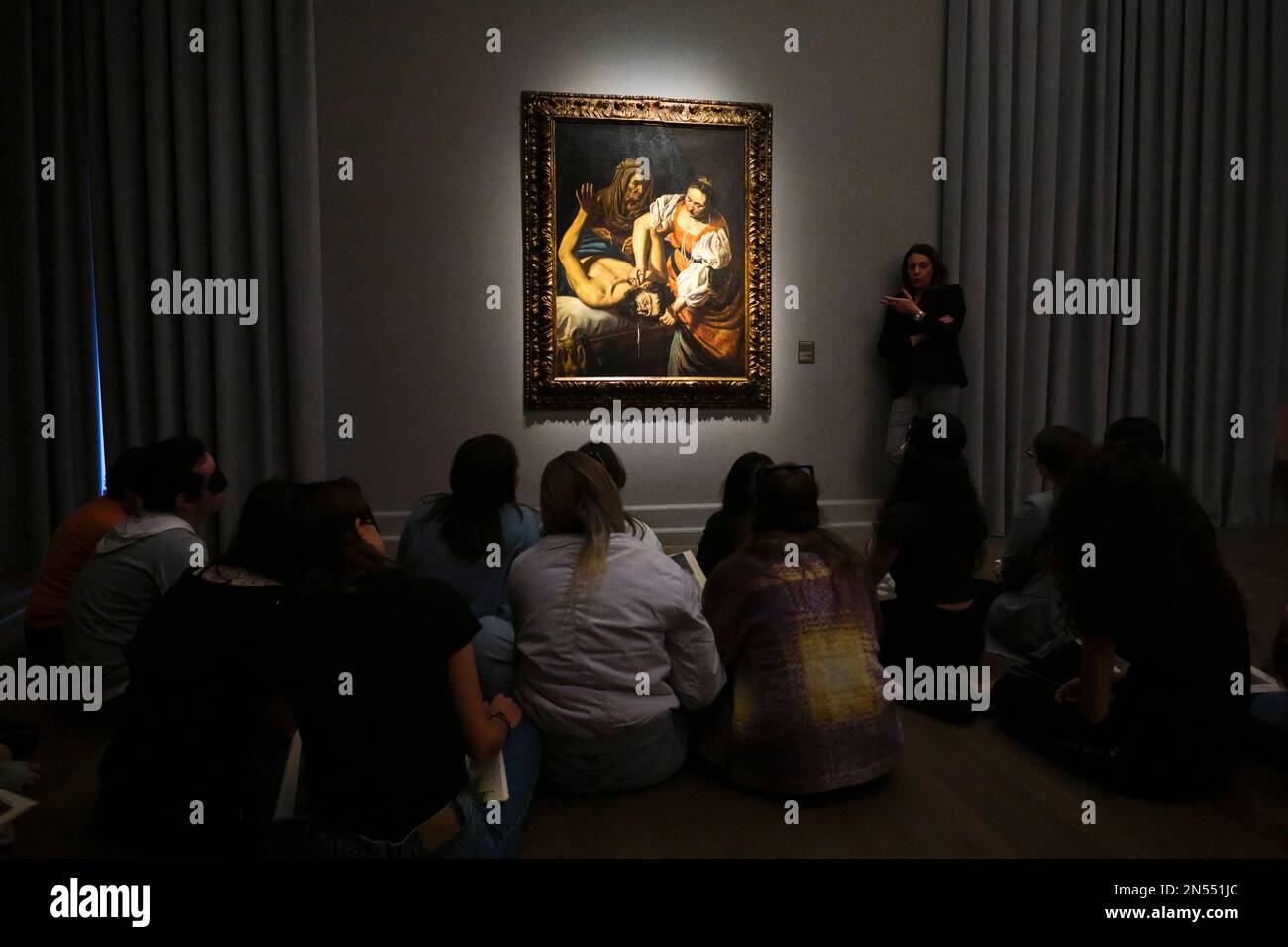 Students sit on the floor, studying Judith Beheading Holofernes, by ...