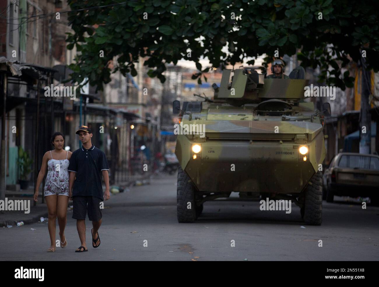 A couple walk pass a Navy armored vehicle during an operation to occupy ...