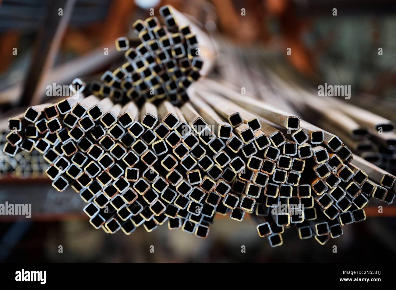 Square tubing pile on rack unit in cold factory warehouse Stock Photo ...