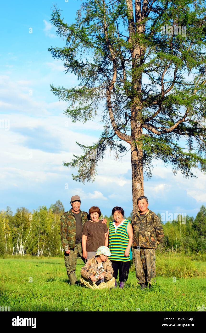 Two Yakut Asian elderly couples men and women with a young girl sitting ...