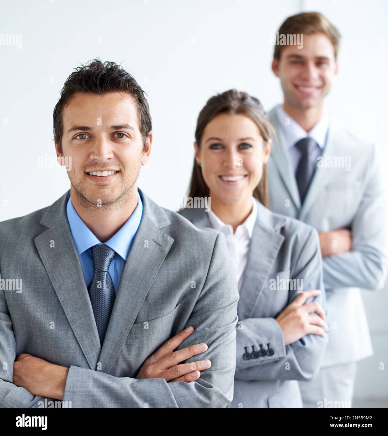 They stand behind their leader. Portrait of a group of smiling ...