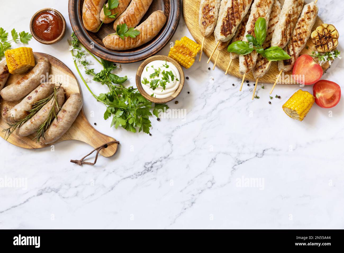 Grill food menu. Various bbq grilled sausages with fresh herbs and ...