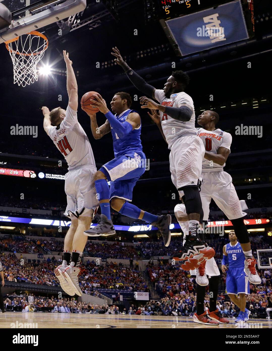 Kentucky's James Young goes up for a shot Louisville's Stephan Van ...