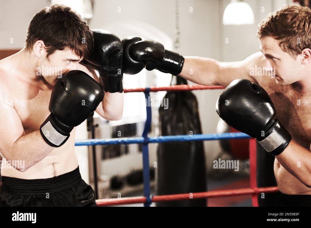 Blocking his flying right hook. Two young boxers fighting it out in the ...