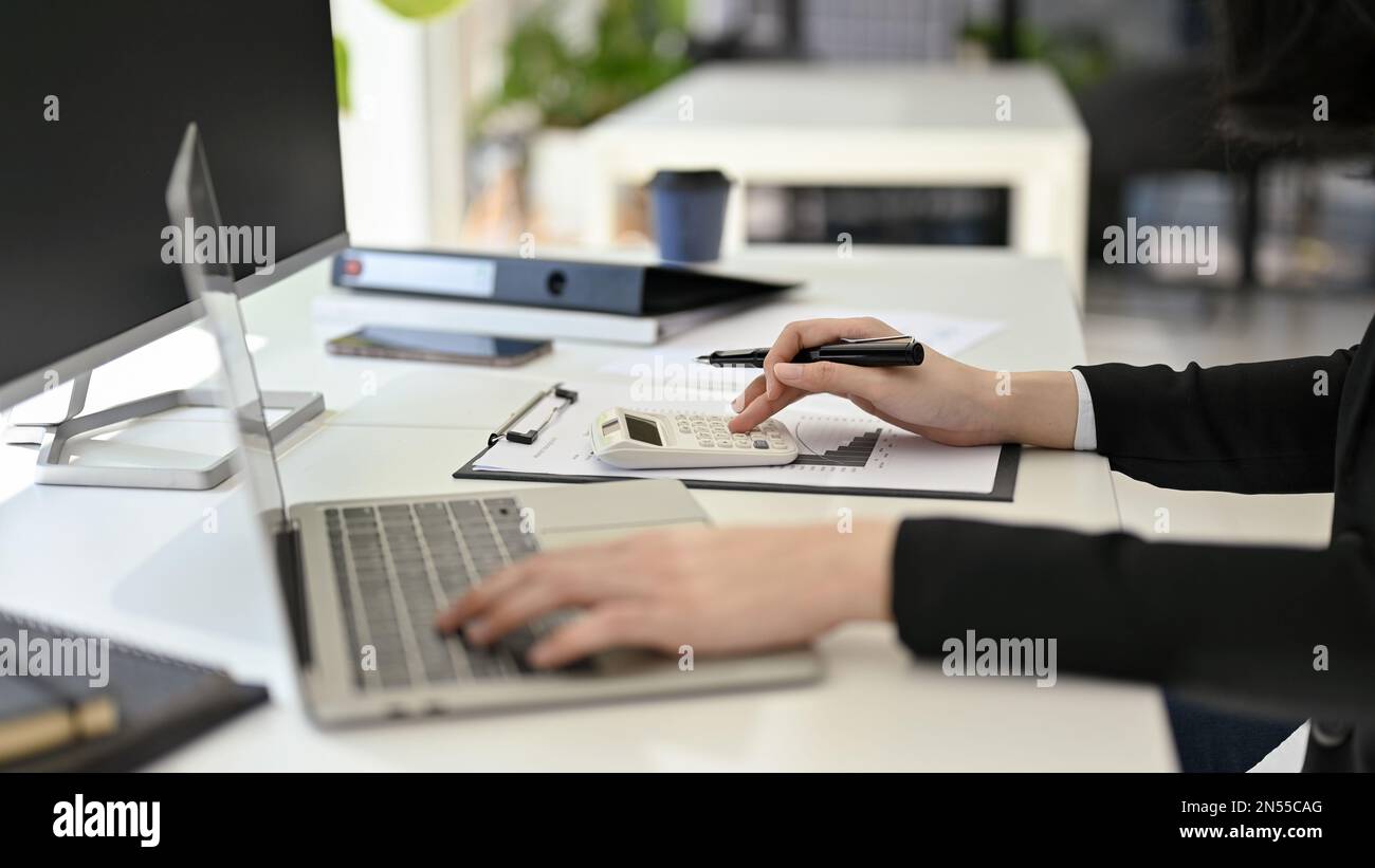 Businesswoman or female accountant working at her desk, using laptop ...