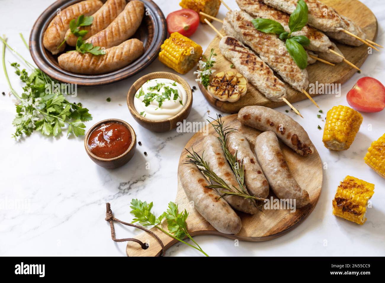 Grill food menu. Various bbq grilled sausages with fresh herbs and ...