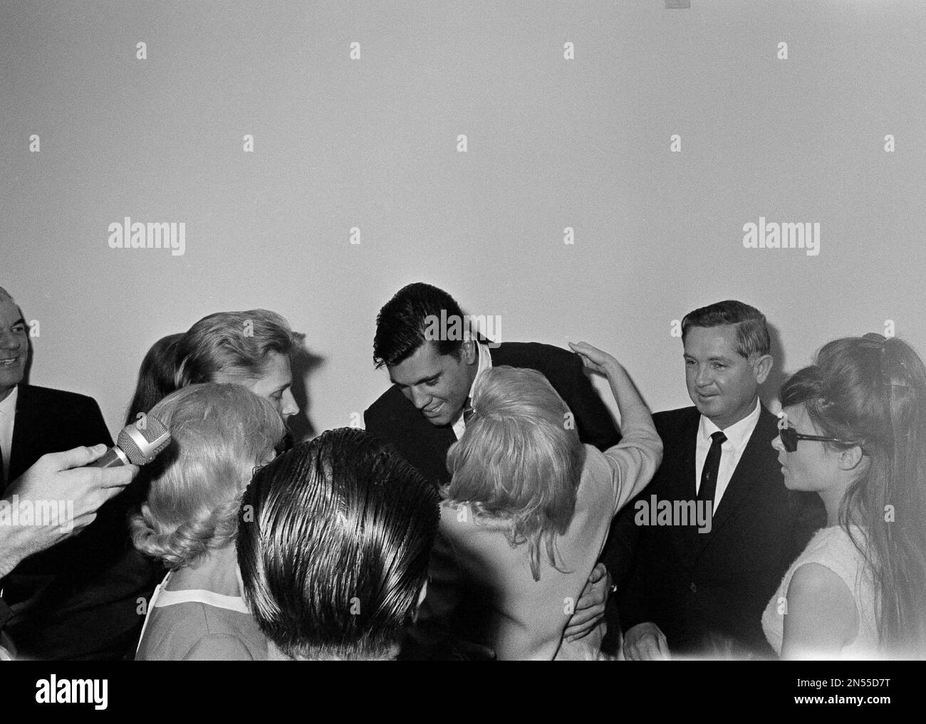 Candace Mossler (back to camera) reaches up to kiss her nephew, Melvin ...