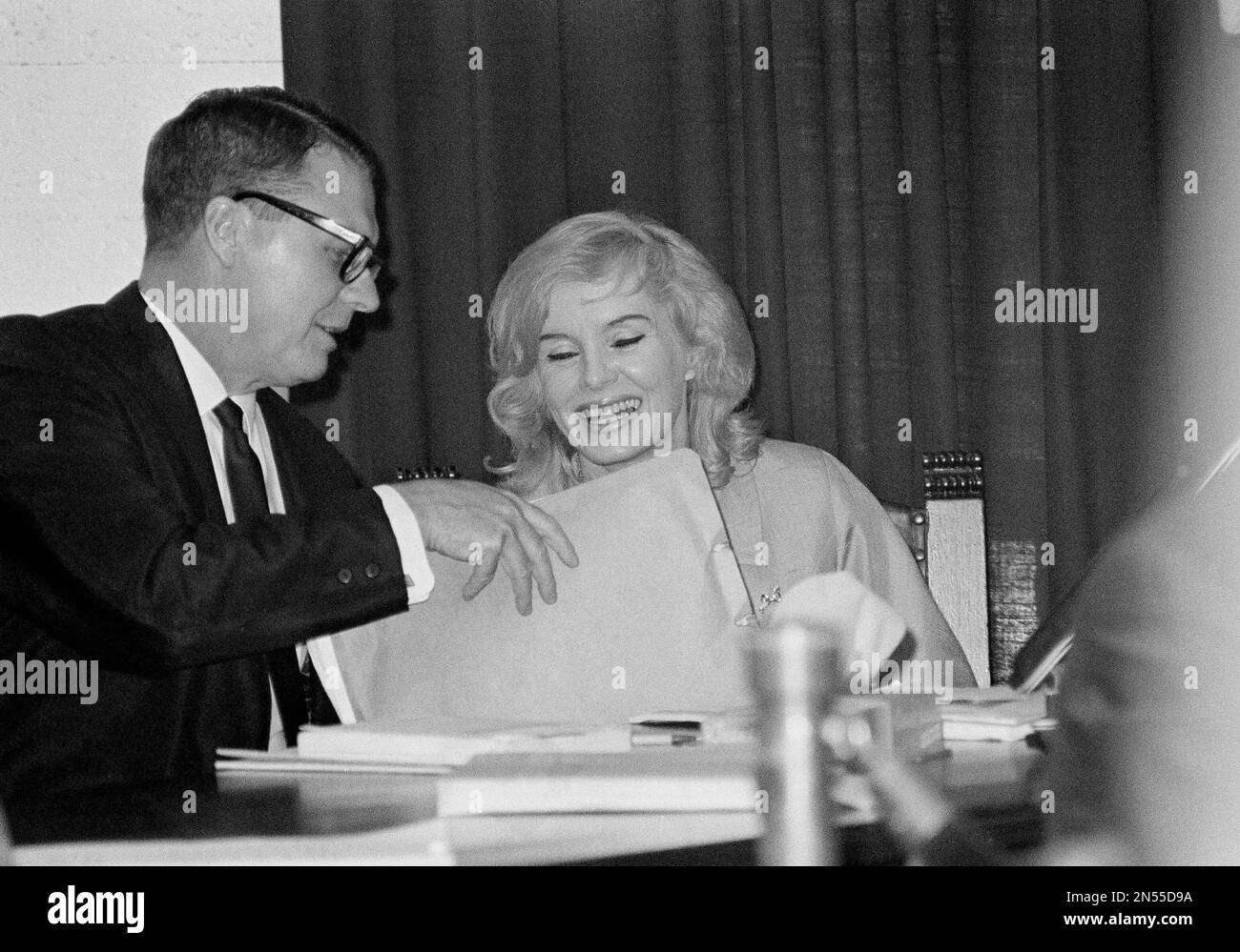 Candace Mossler flashes a big smile as she confers with one of her ...